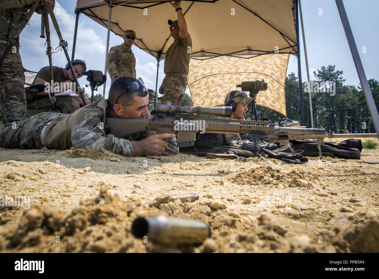 Albanian special forces sniper Staff Sgt. Ajet Disha, front, prepares ...