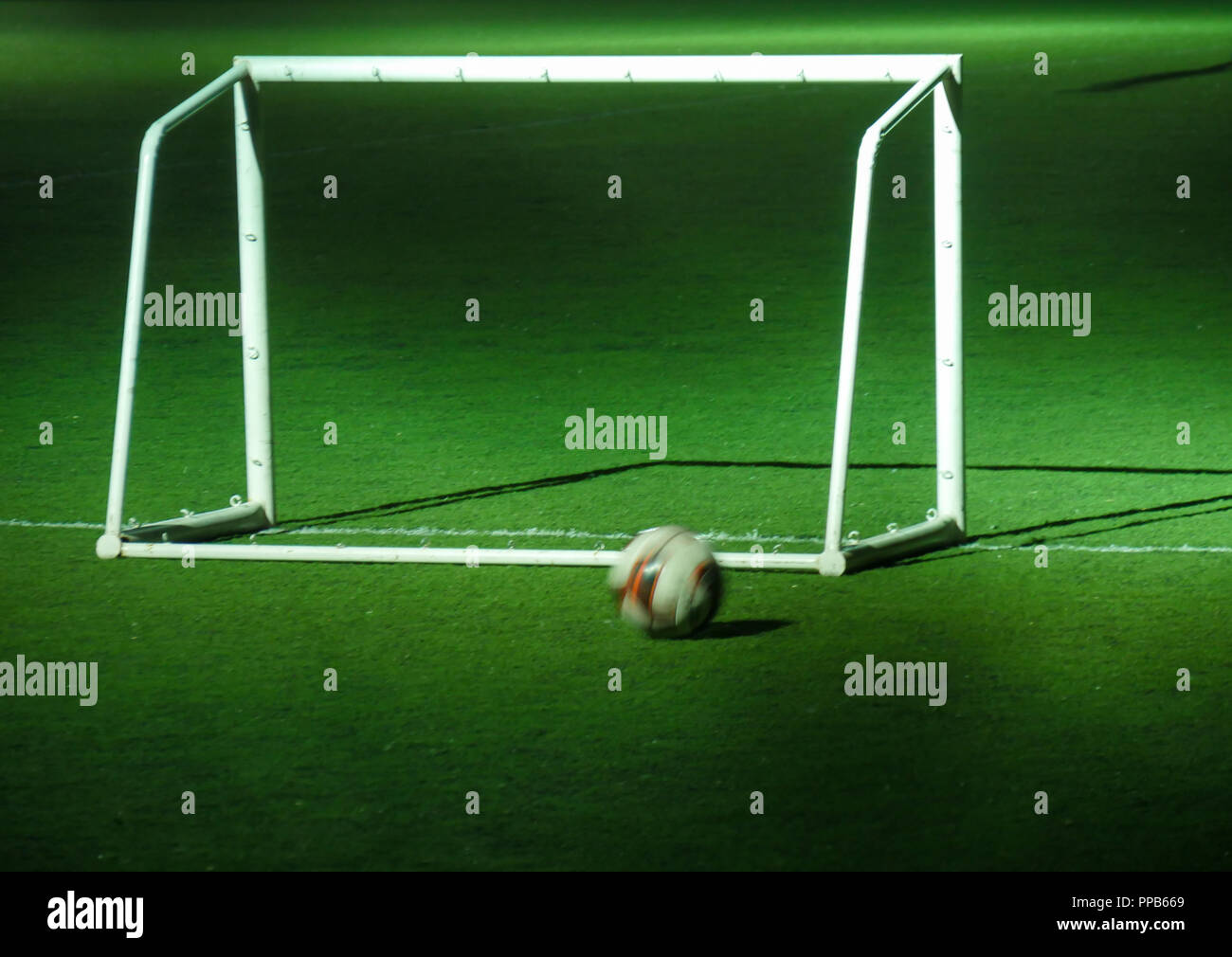 Soccer ball and goalpost on stadium field at night Stock Photo - Alamy