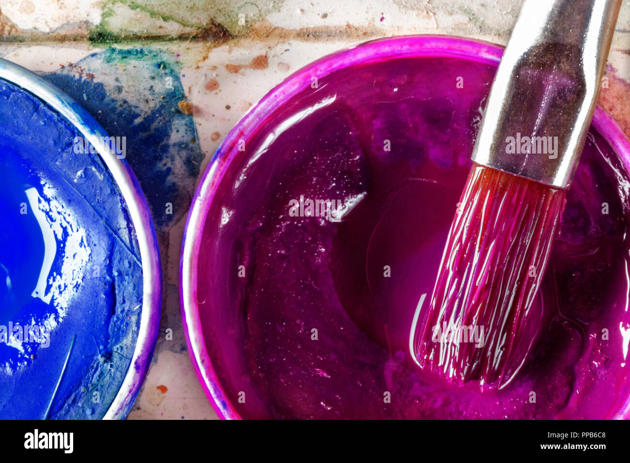 A small set of two watercolors , blue and purple colors in small round ...