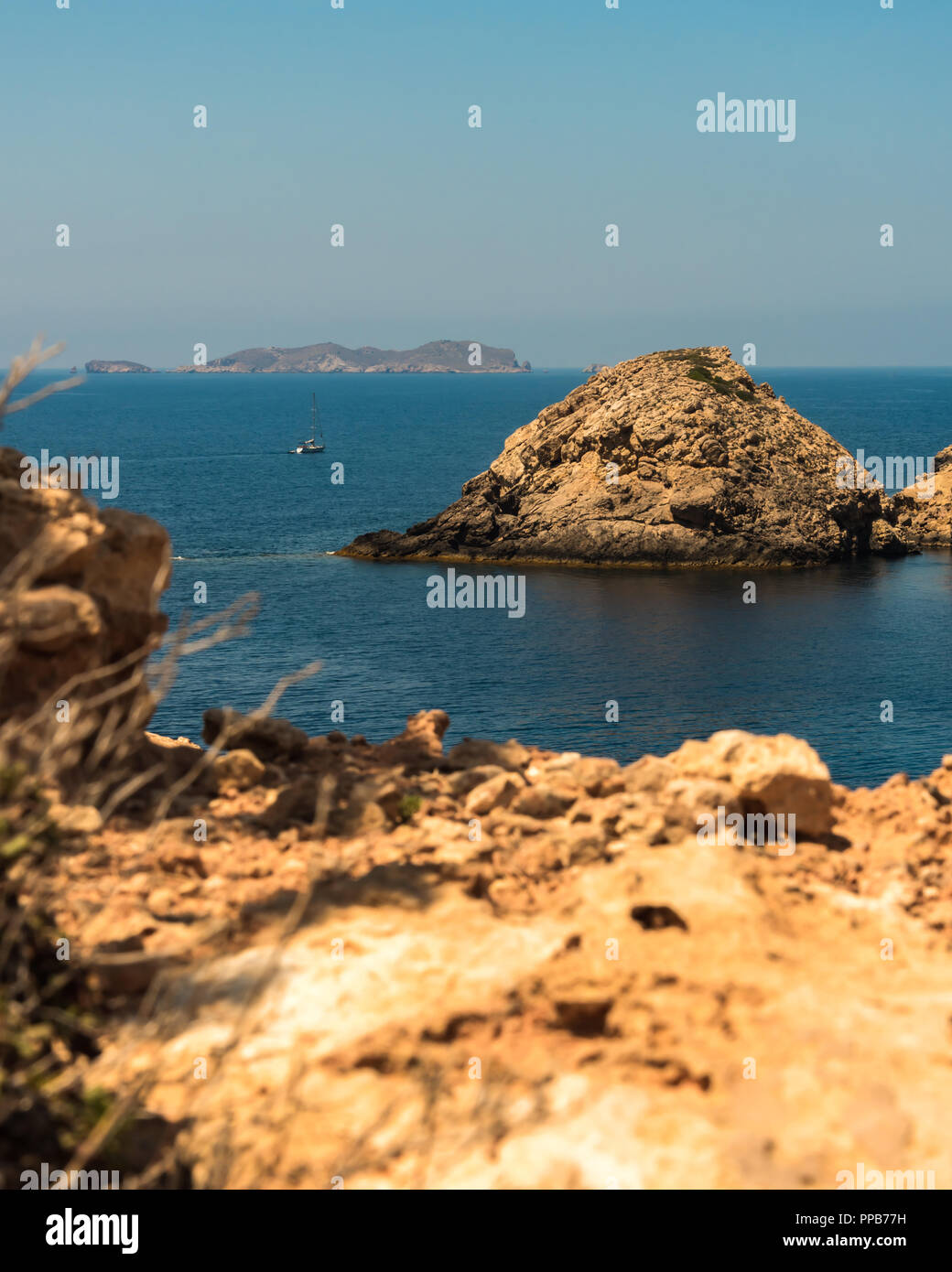 A ship sails between the rocks in the bay near Ibiza Stock Photo - Alamy