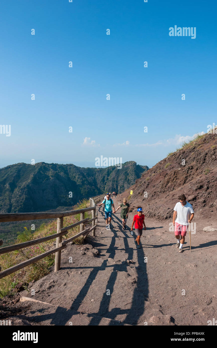 MOUNT VESUVIUS, ITALY - AUGUST 1, 2018: Tourists walk around the crater ...