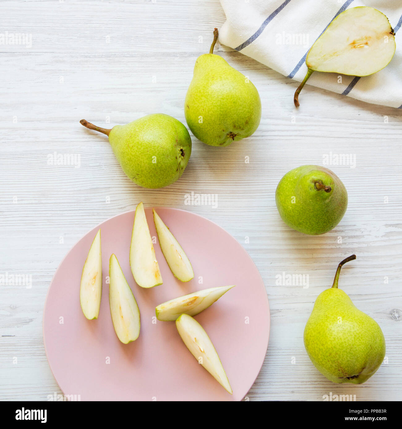 Fresh pears on white wooden background, overhead view. From above, top ...
