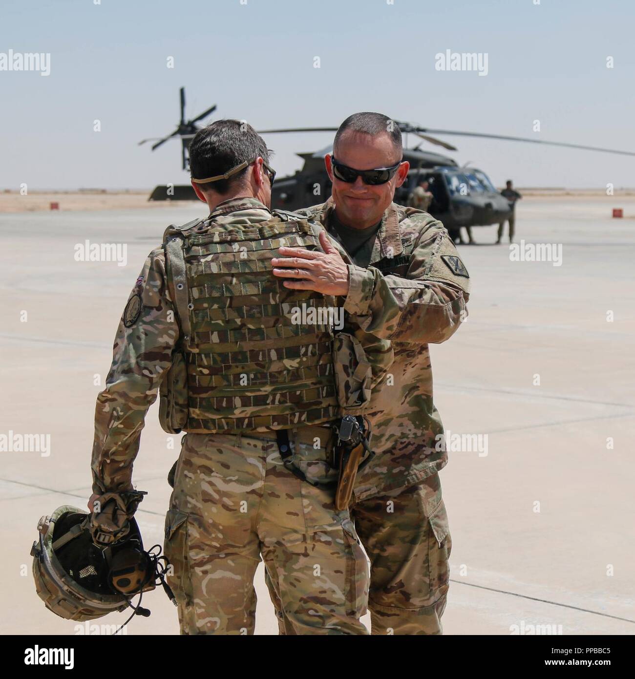 U.S. Army Col. Michael Maddox, center, Al Asad Air Base commander ...
