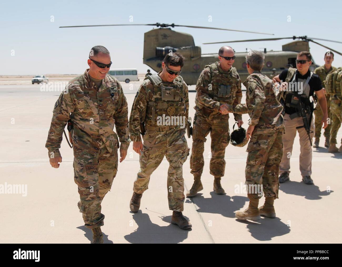U.S. Army Col. Michael Maddox, left, Al Asad Air Base commander, greets ...