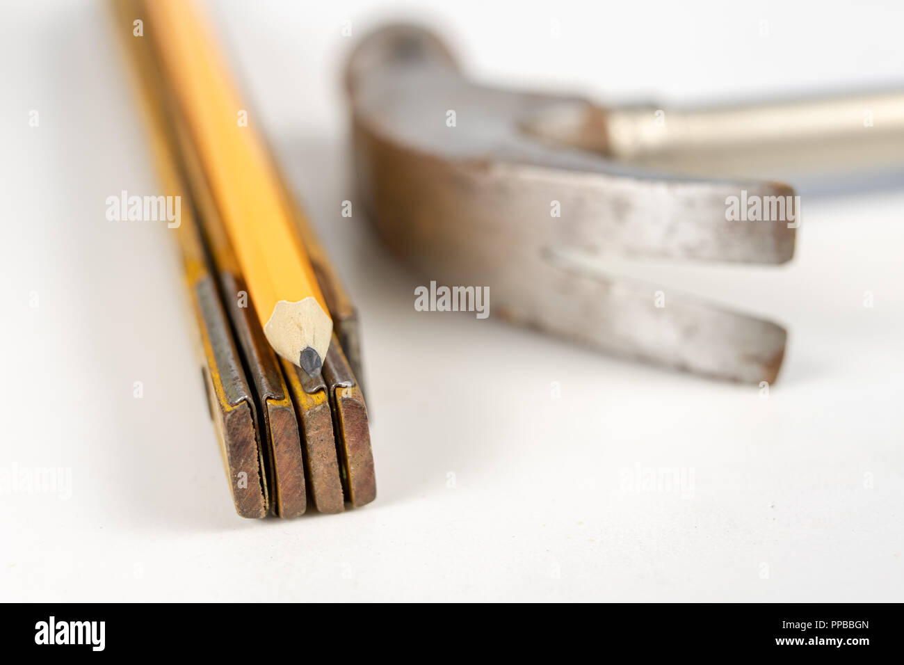 Measure and pencil on a white workshop table. Tools in a carpentry ...