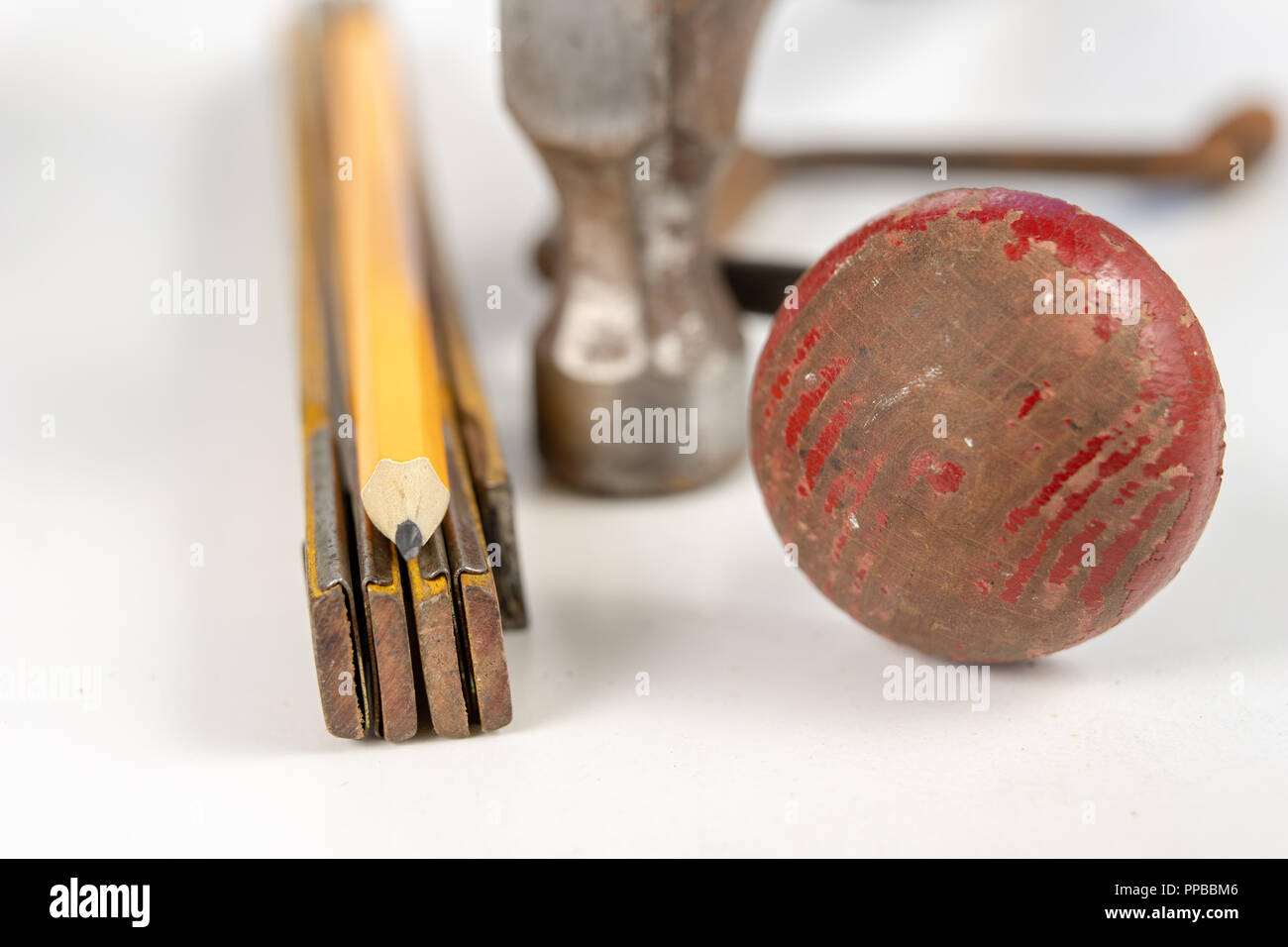 Measure and pencil on a white workshop table. Tools in a carpentry ...