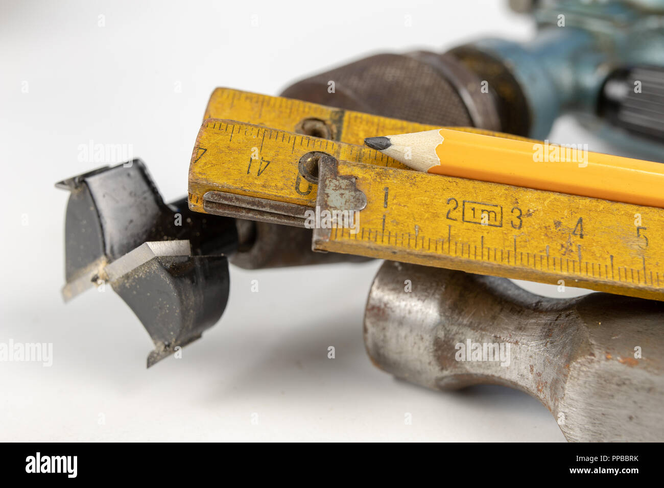 Measure and pencil on a white workshop table. Tools in a carpentry ...