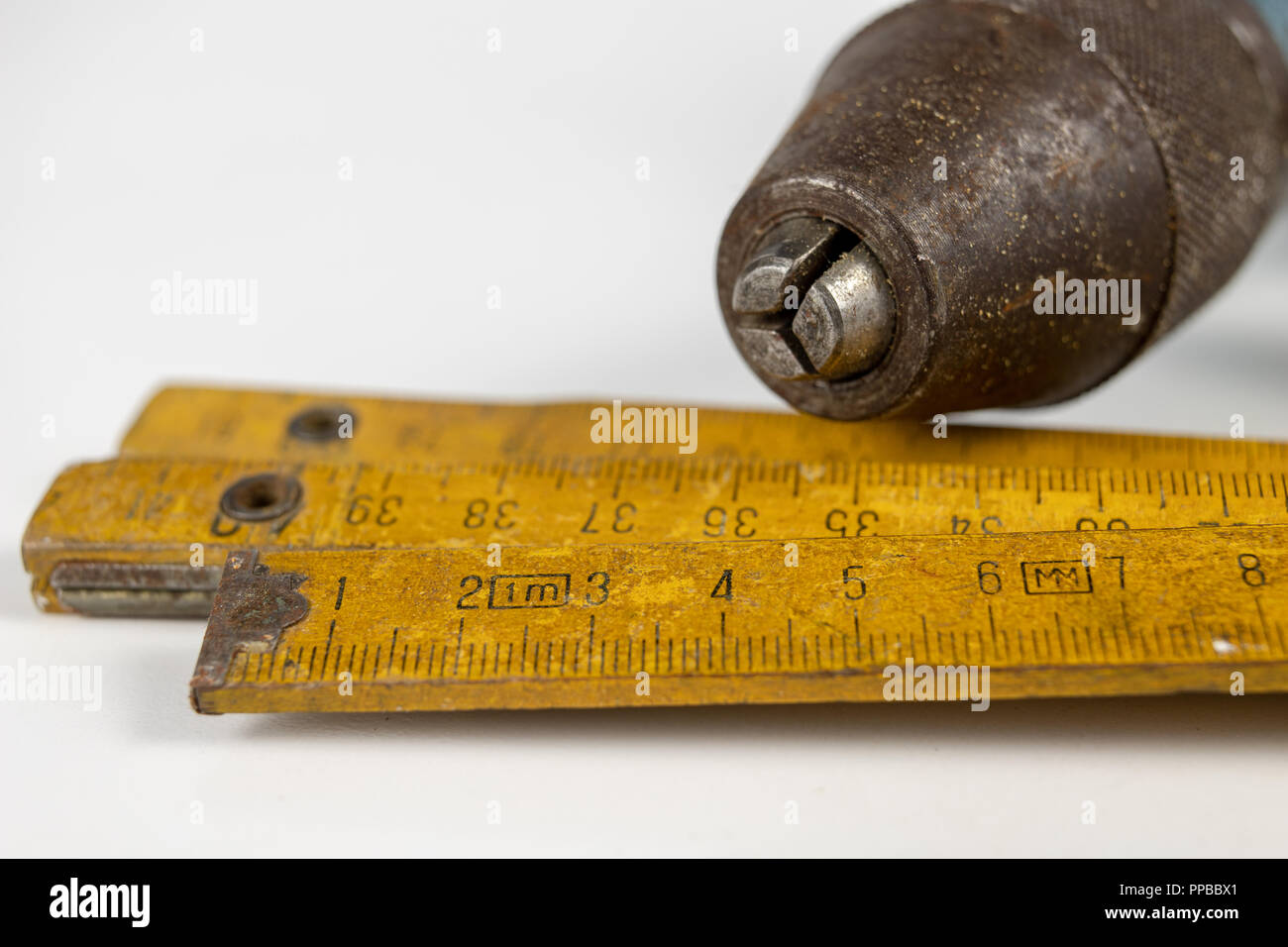 Measure and pencil on a white workshop table. Tools in a carpentry ...
