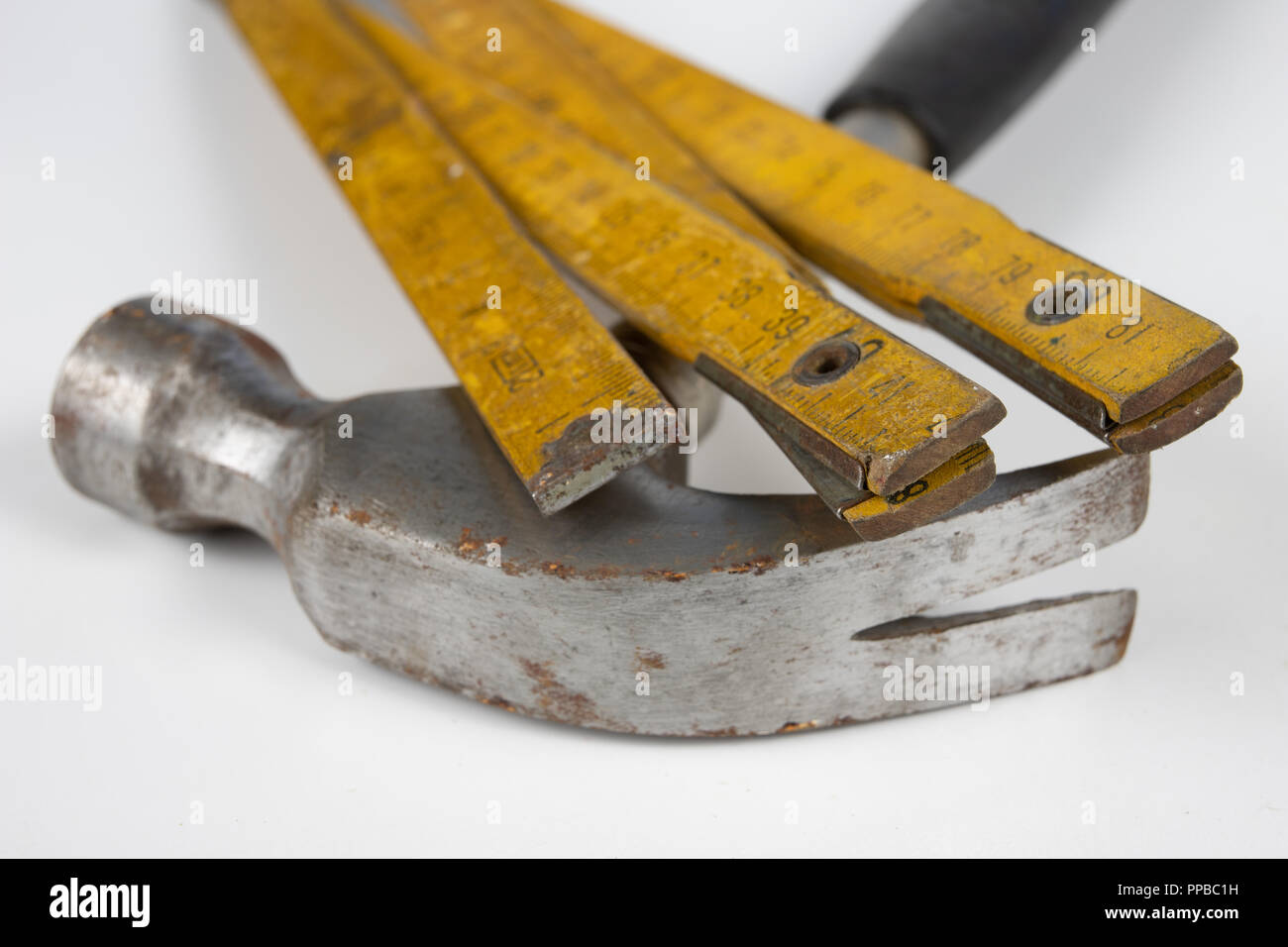 Measure and pencil on a white workshop table. Tools in a carpentry ...