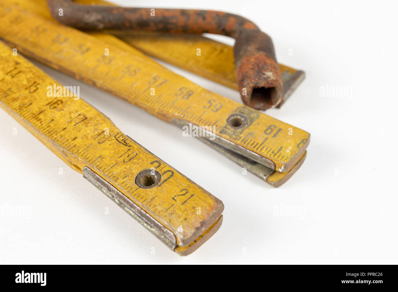Measure and pencil on a white workshop table. Tools in a carpentry ...