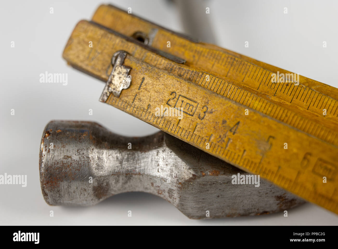 Measure and pencil on a white workshop table. Tools in a carpentry ...