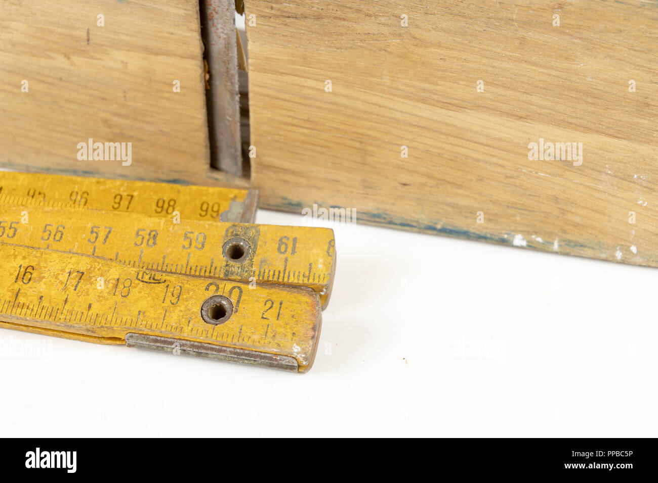 Measure and pencil on a white workshop table. Tools in a carpentry ...