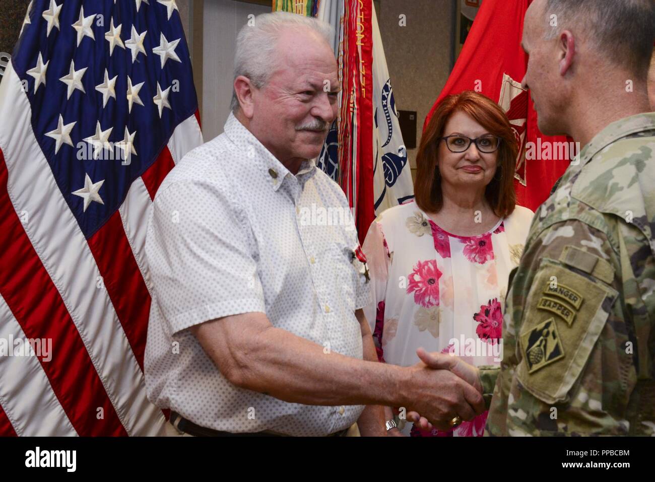 James C. Melton accompanied by his wife Joanne Melton shakes hand with ...