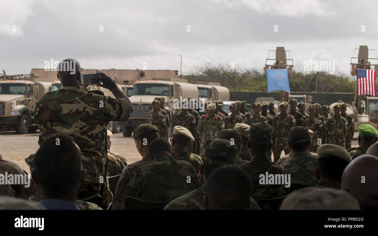 A distinguished visitor snaps a photo of the graduating class during a ...