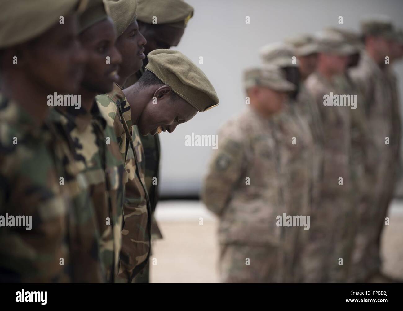 A Somali national army soldier stands in formation awaiting to receive ...