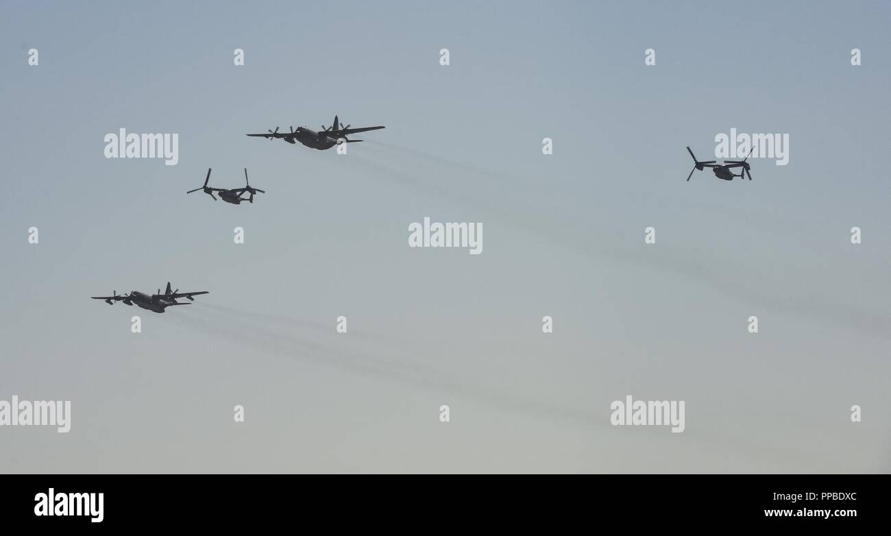 An AC-130U Spooky gunship, MC-130H Combat Talon II and two CV-22 Osprey ...