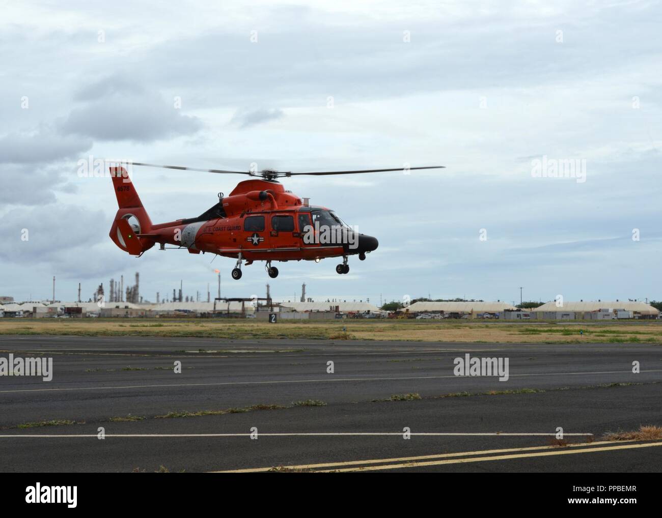 A Coast Guard MH-65 Dolphin helicopter aircrew takes off at Air Station ...