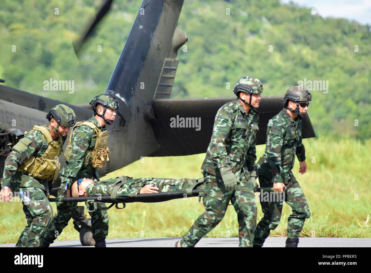 Royal Thai Army rangers unload a patient from a 16th Combat Aviation ...