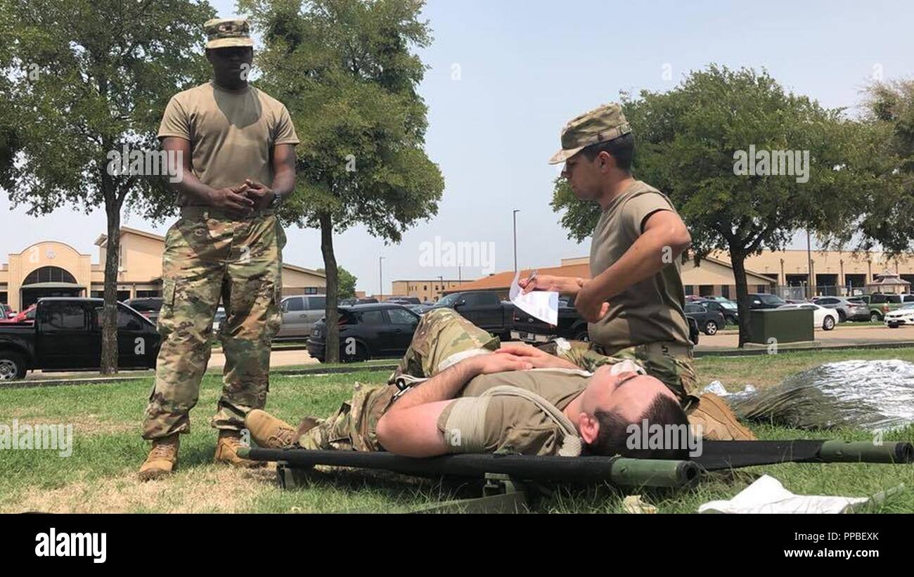 An Army Reserve Sergeant and medial evaluator looks on as a Soldier ...