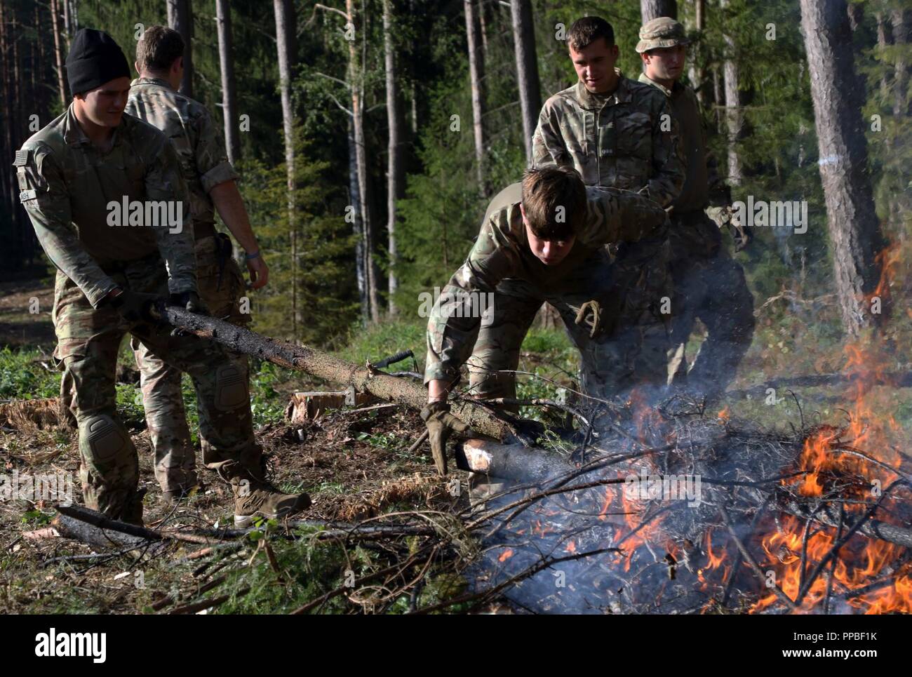 U.S. and U.K. Army Soldiers attempt to put out a fire without water ...
