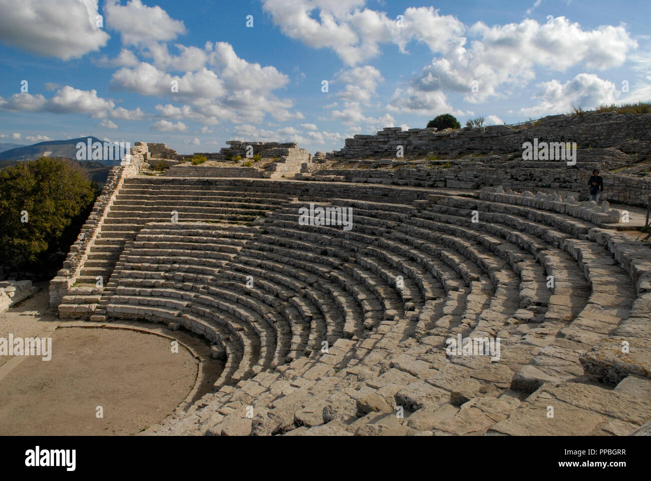 The amphitheatre at Segesta, Sicily, Italy under a blue sky with white ...