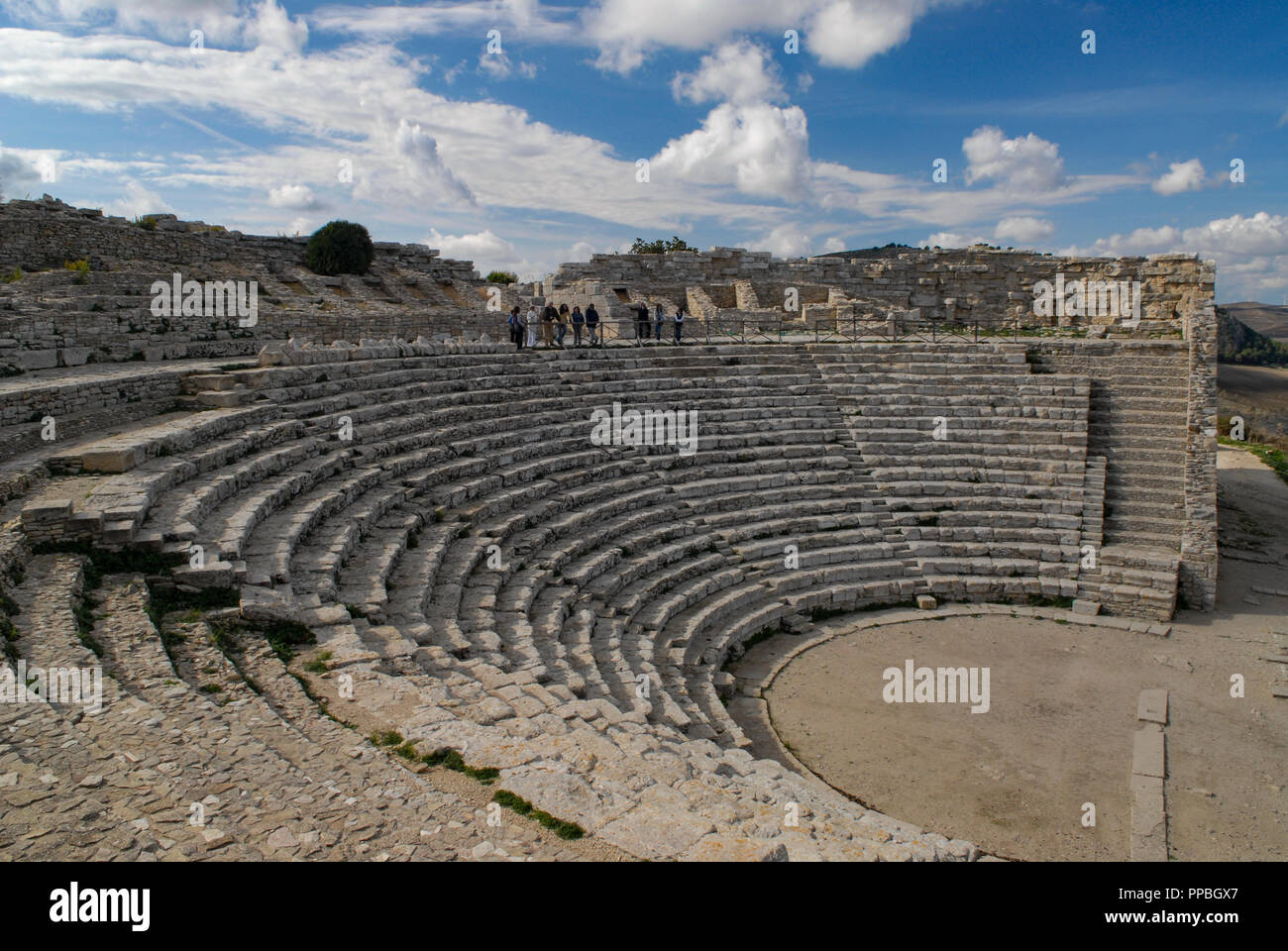 The amphitheatre at Segesta, Sicily, Italy under a blue sky with white ...