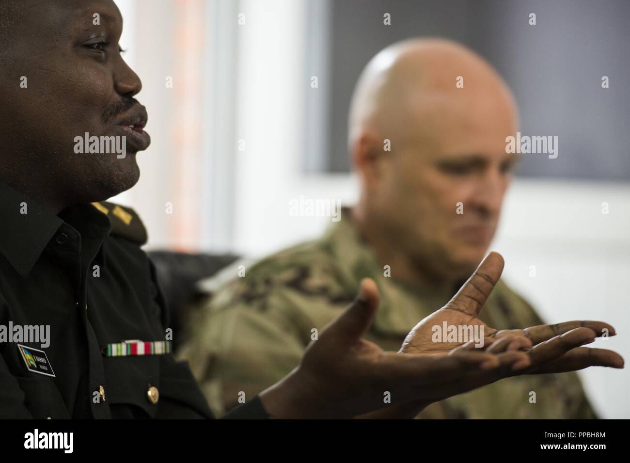 Rwanda Army Maj. Ernest Nahayo, interacts with Dr. Marcel Uwizeye ...