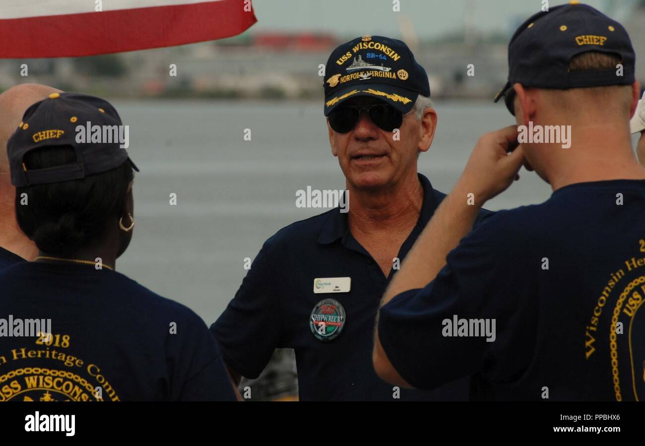 A staff member from Nauticus speaks shares a moment with local Chief ...