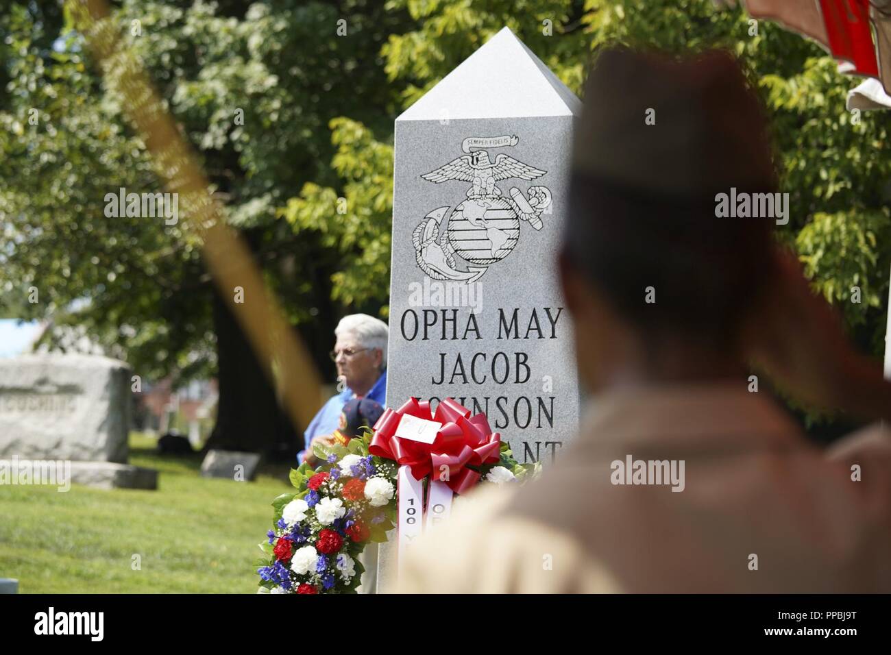 A Marine salutes as taps is played at the unveiling of a monument at ...