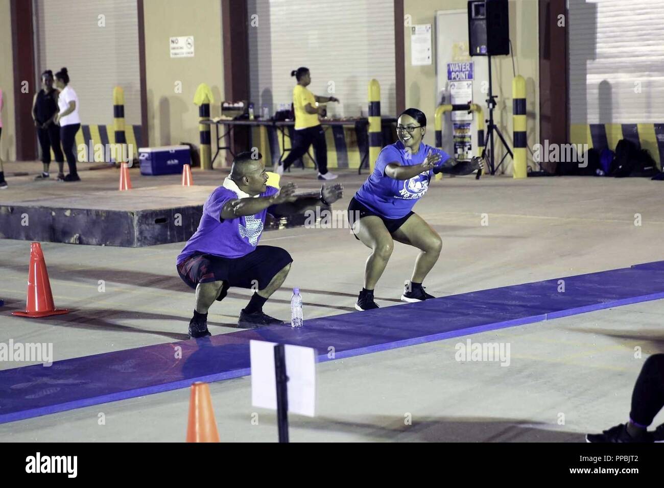 Camp As-Sayliyah, Qatar – Two Soldiers share a smile during a squat ...