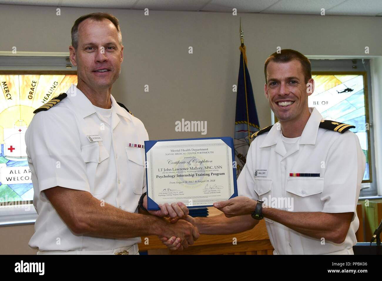 Capt. Devin Morrison, NMCP acting executive officer, presents Lt. John ...