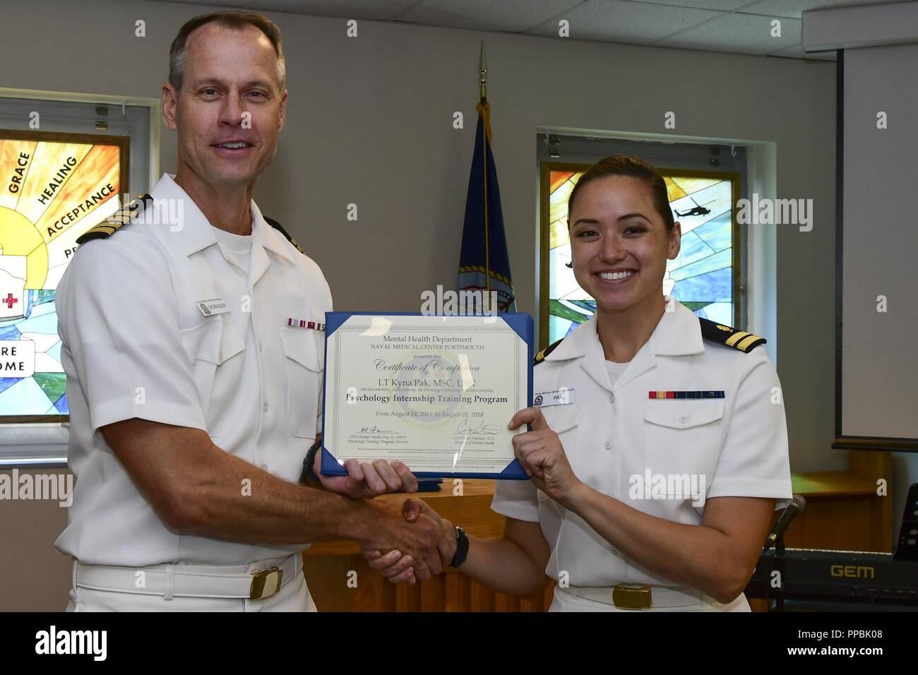 Capt. Devin Morrison, NMCP acting executive officer, presents Lt. Kyna ...