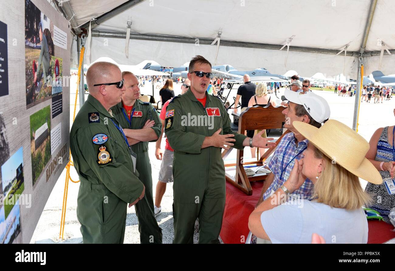 Members of the Royal Air Force speak to members of the Offutt family in ...