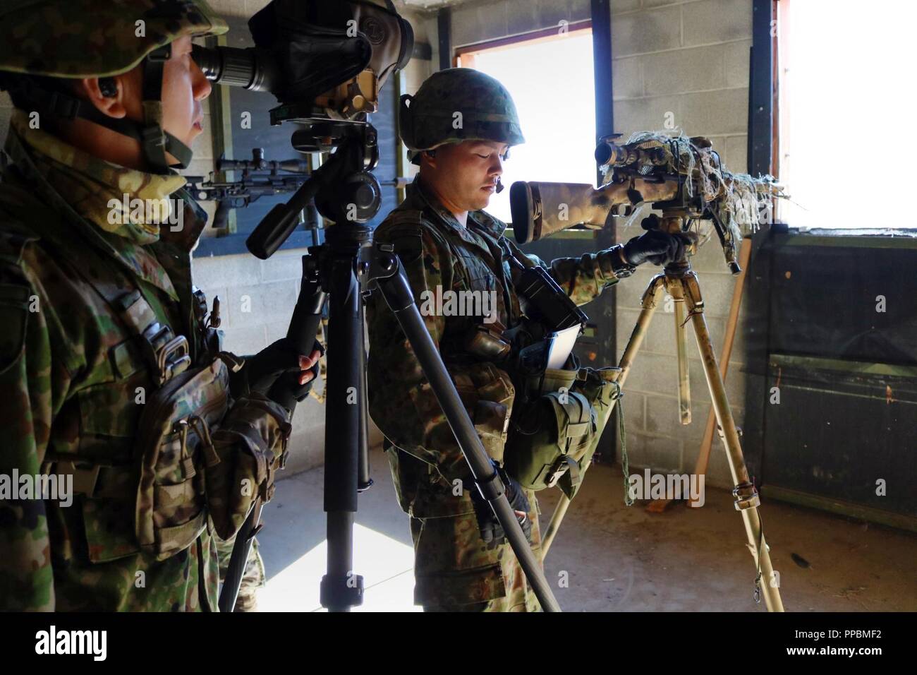 Soldiers from the Japanese Ground Self Defense Force adjusts their ...