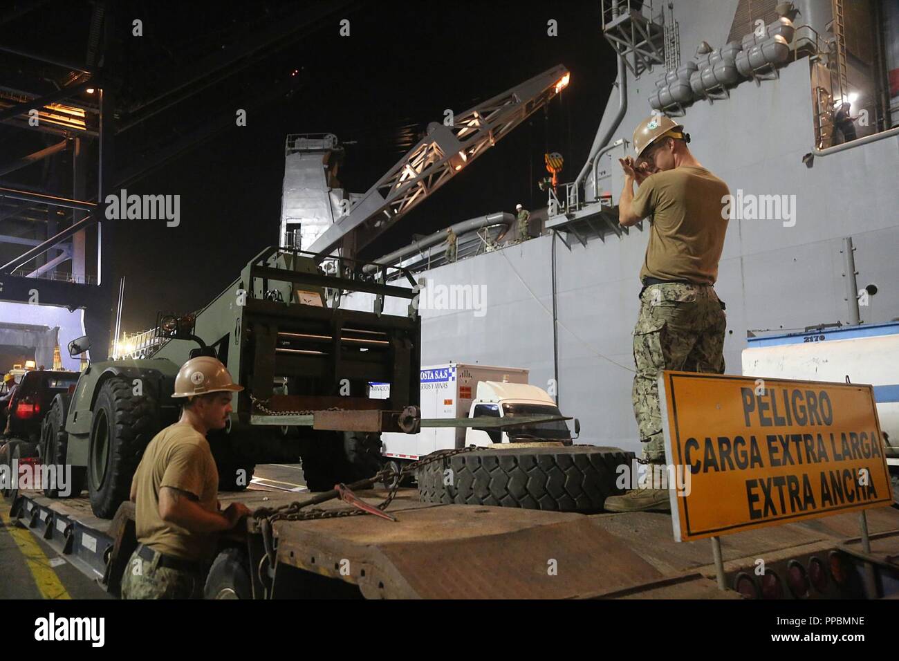 U.S. Navy Seabees, Naval Mobile Construction Battalion 133, guide their ...