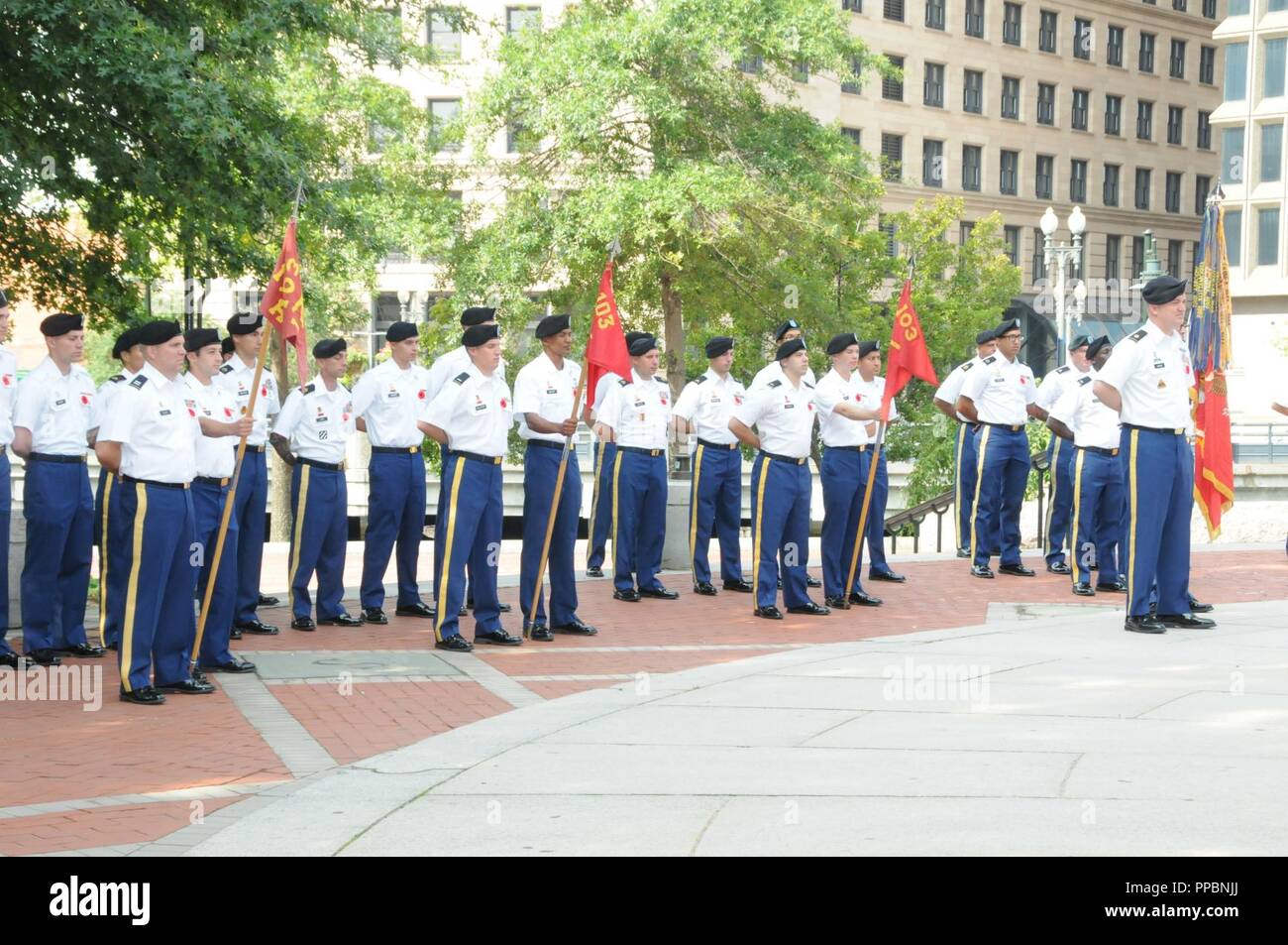 Members of the 103rd Field Artillery Battalion stand in formation ...