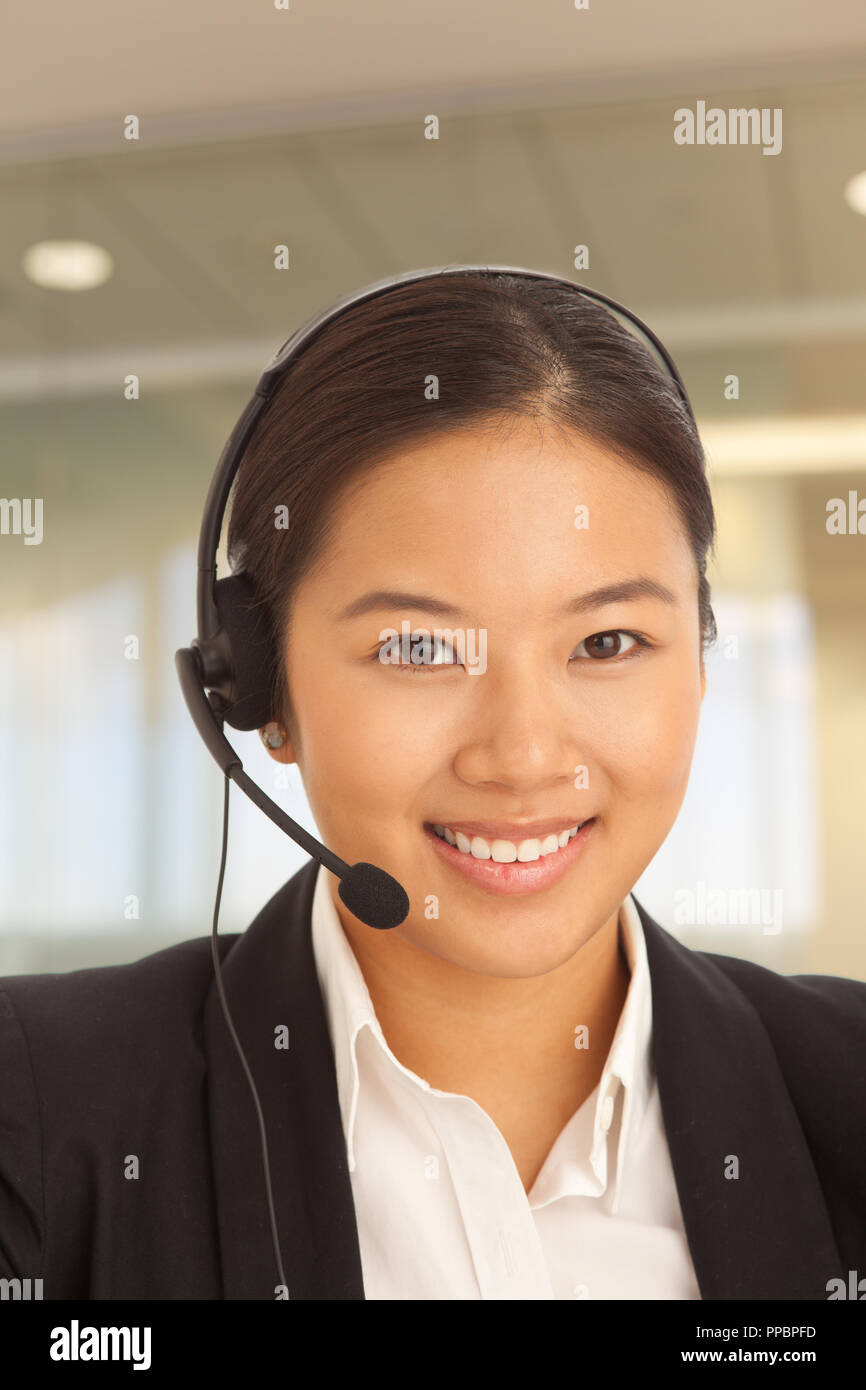 Cute millennial female telemarketer smiling at work inside office ...