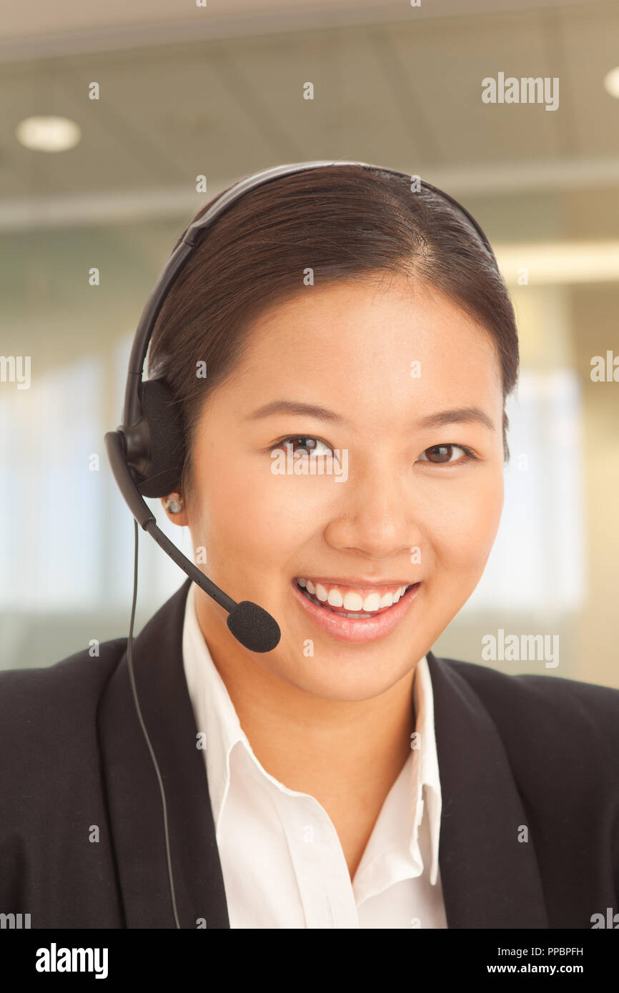 Cute millennial female telemarketer smiling at work inside office ...