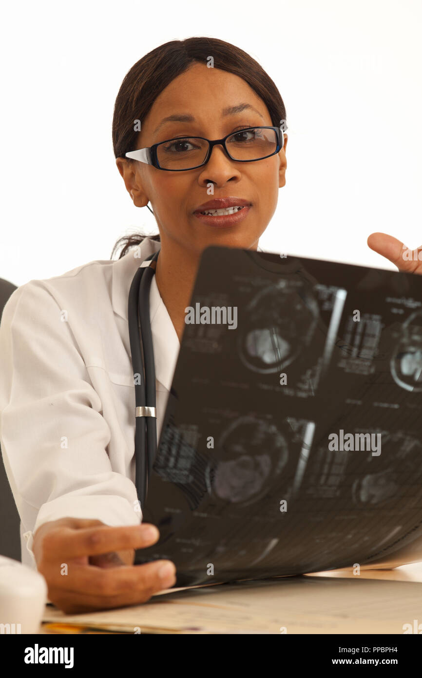 Closeup of young African doctor examining ct scan of patients cranium ...