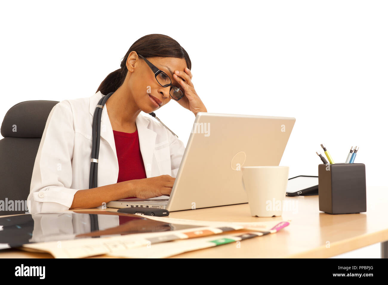Stressed young female physician using laptop computer Stock Photo - Alamy