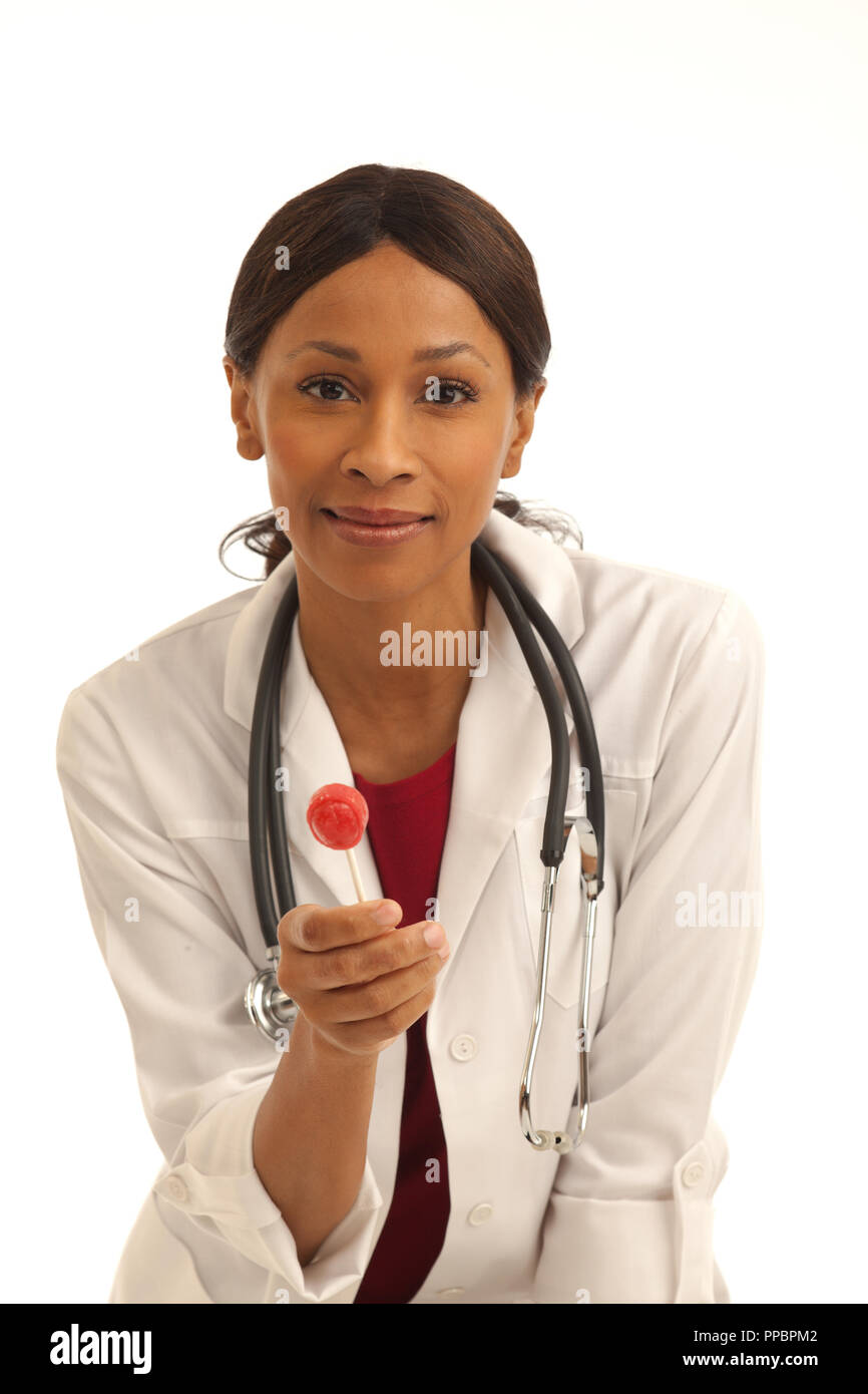 Portrait of nice female doctor holding out lollipop candy Stock Photo ...
