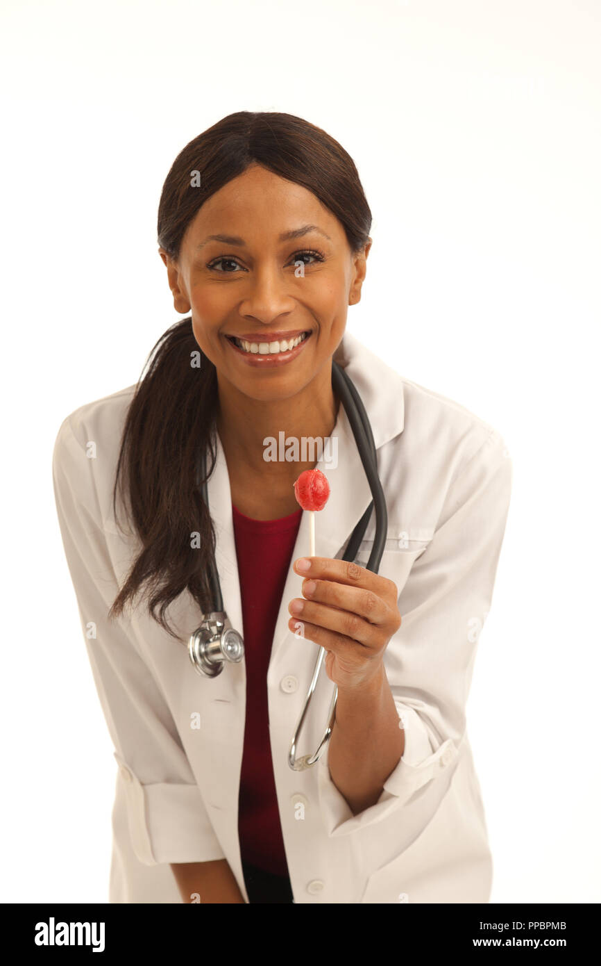 Portrait of nice female doctor holding out lollipop candy Stock Photo ...