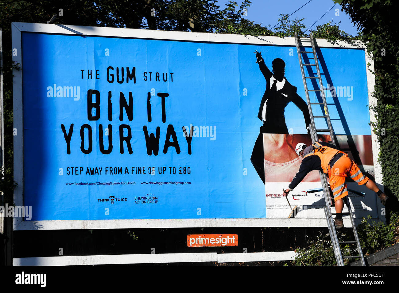 North London. London. UK 25 Sept 2018 - A man puts a “The Gum Strut Bin ...