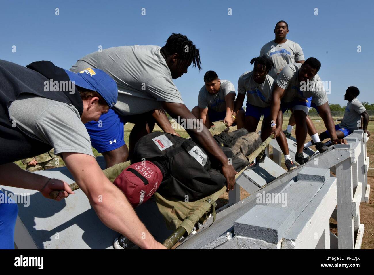 Angelo State University students carry a 200-pound litter on the Miller ...