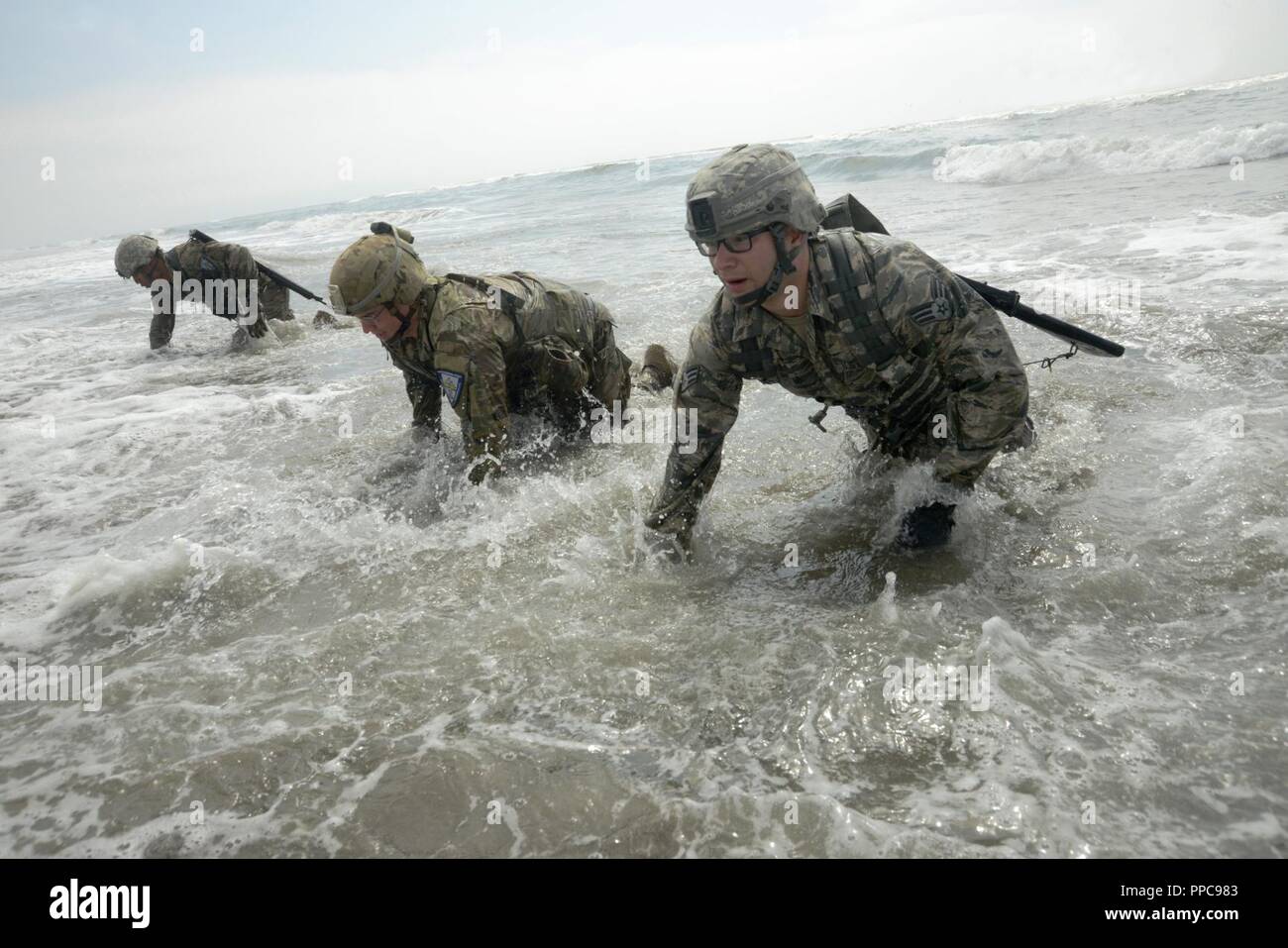 Oregon Army and Air National Guardsmen high crawl through the Pacific ...