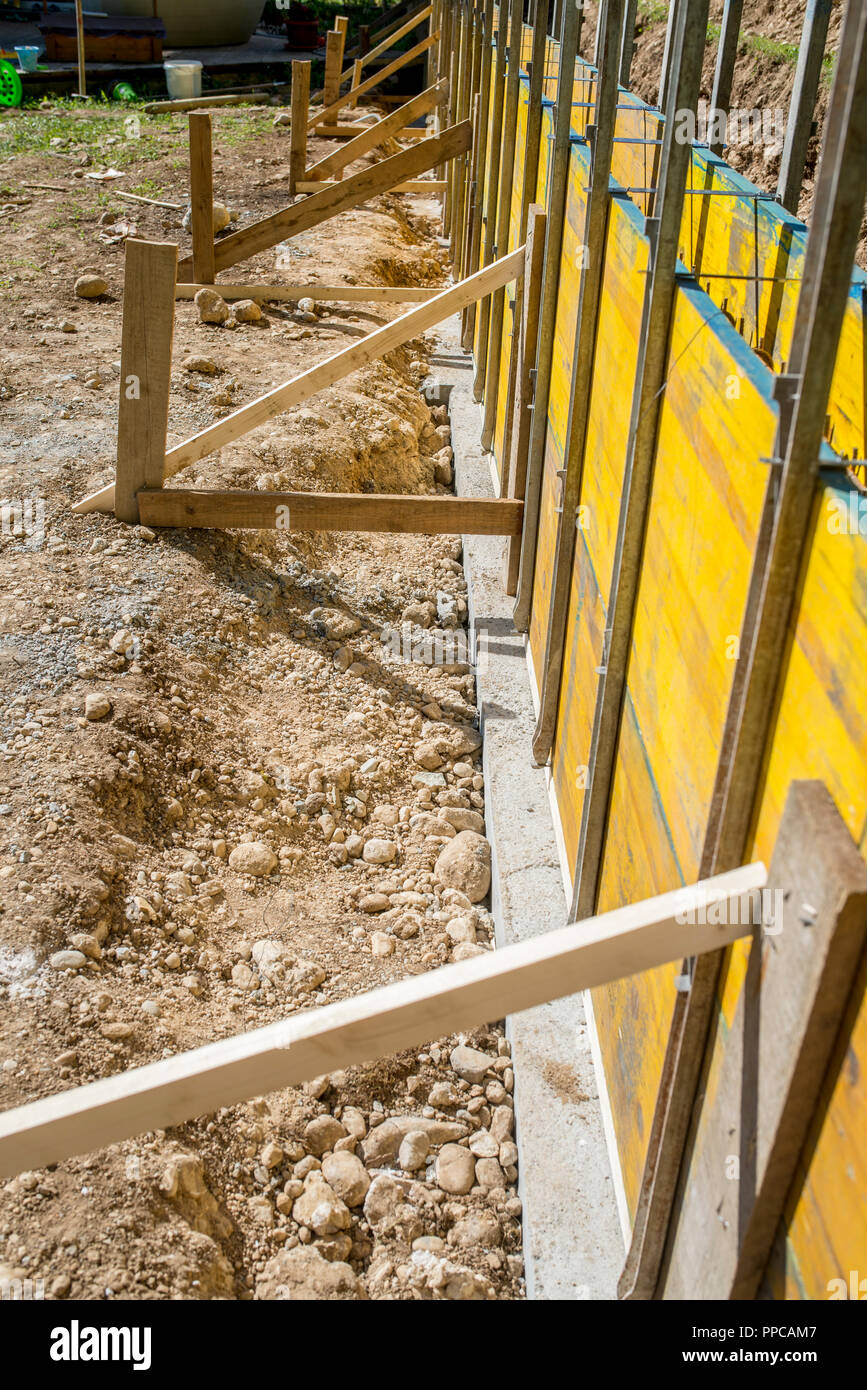 Construction site with supported wooden yellow panels forming a frame ...