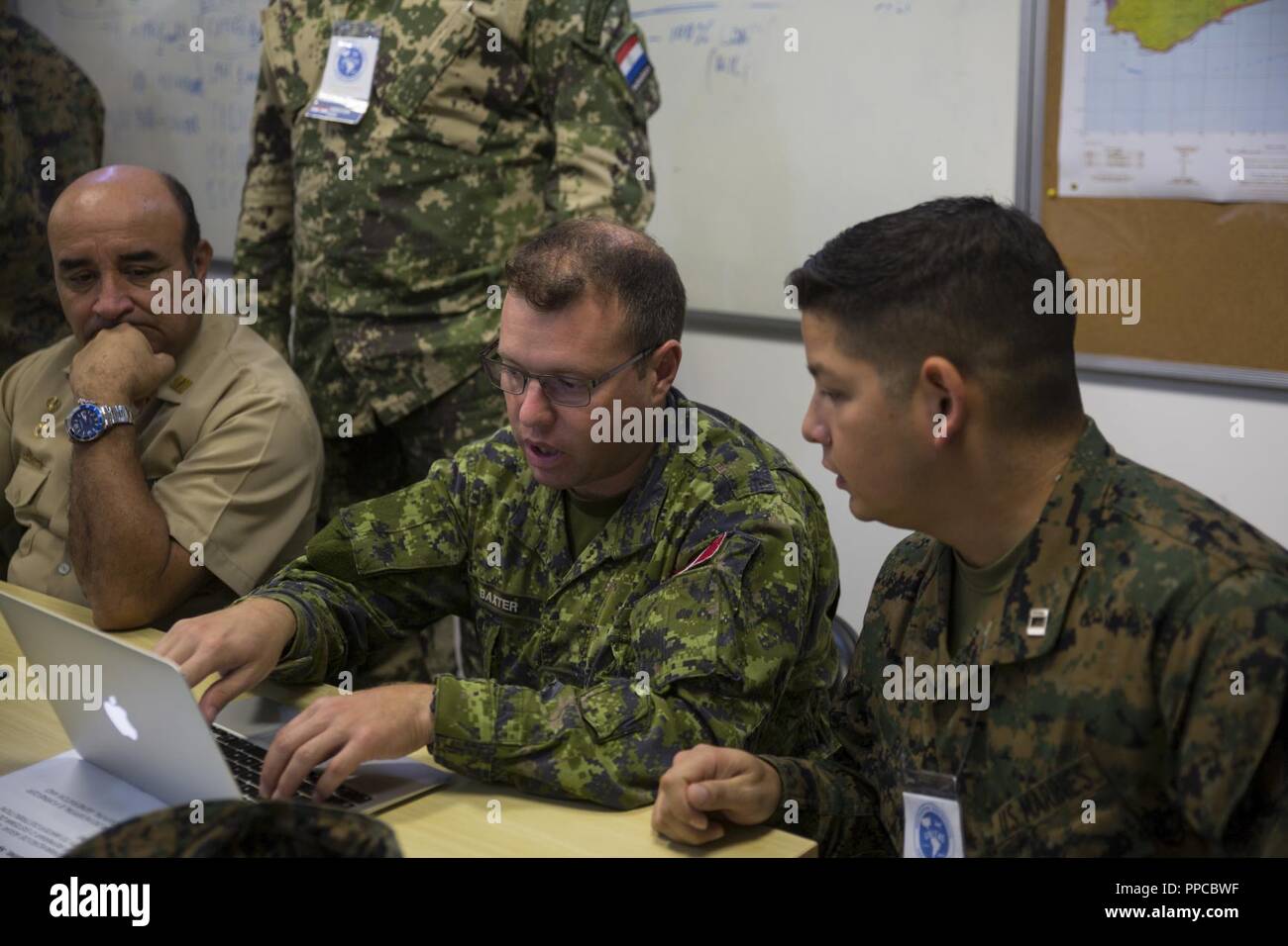 Canadian Army Capt. Adam Baxter works with U.S. Marine Capt. Antonio ...