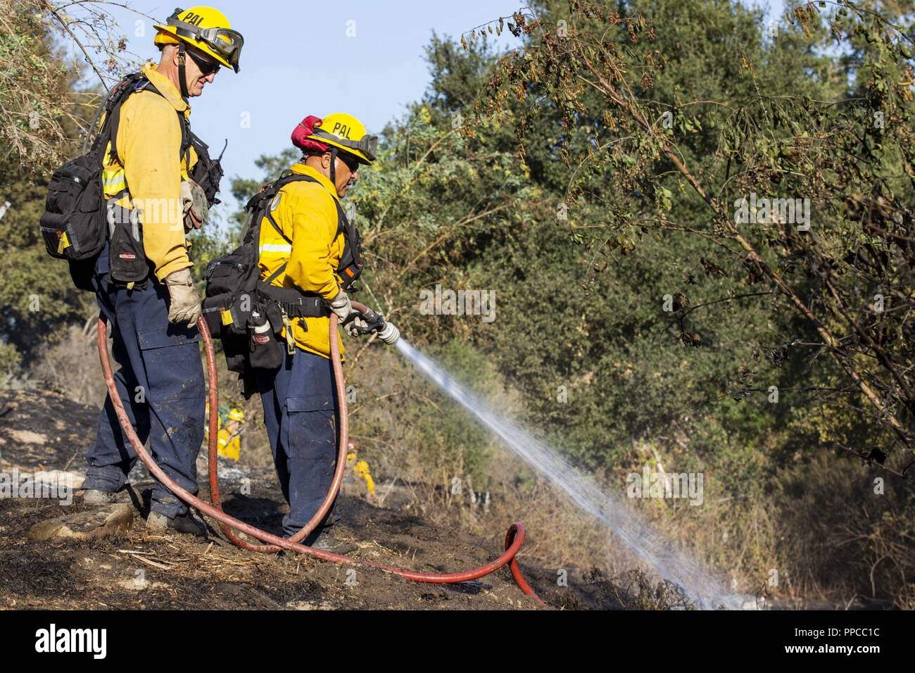 Firefighters with the Camp Pendleton Fire Department combat a fire in ...