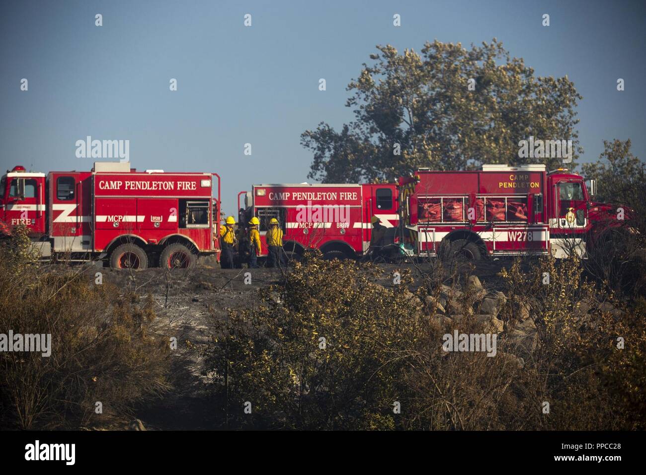 Firefighters with the Camp Pendleton Fire Department and CAL Fire ...