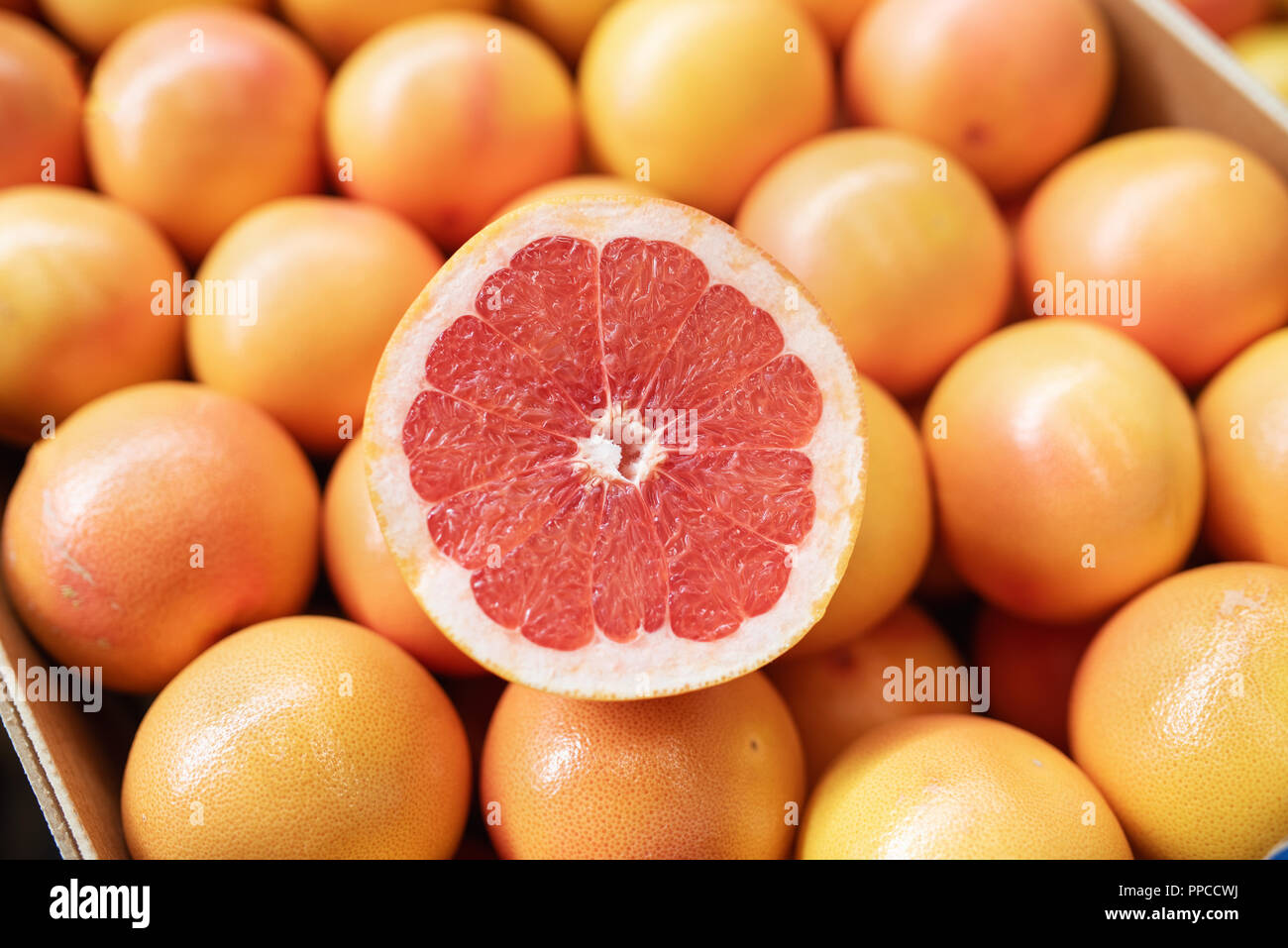 Grapefruit in boxes in store. shelf with fruits. healthy food concept ...